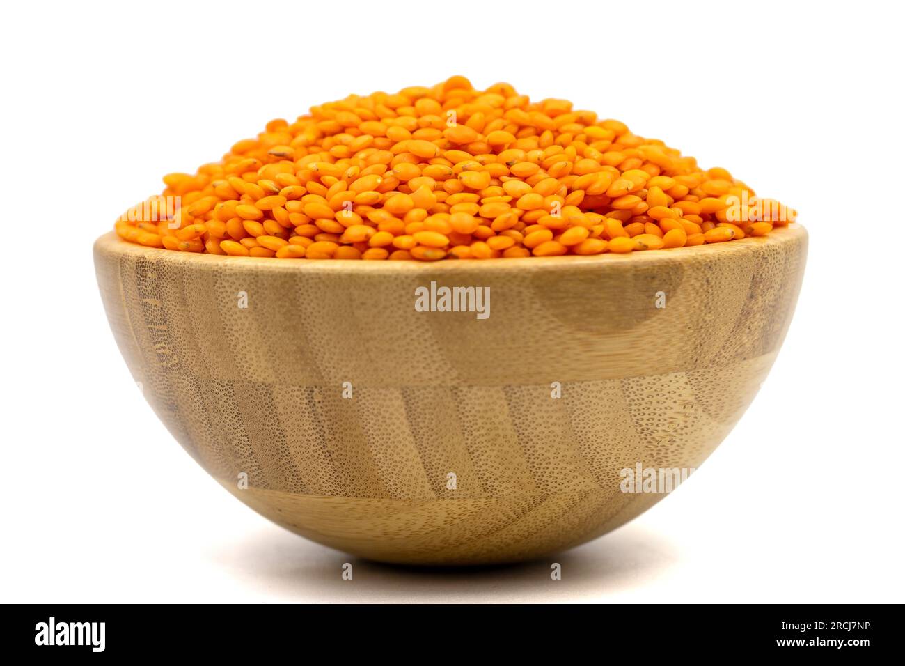 Red lentils isolated on white background. Raw red lentils in wooden bowl Stock Photo - Alamy