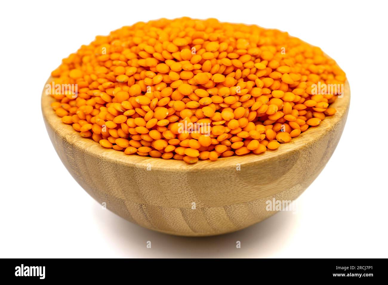 Red lentils isolated on white background. Raw red lentils in wooden bowl. Close up Stock Photo ...