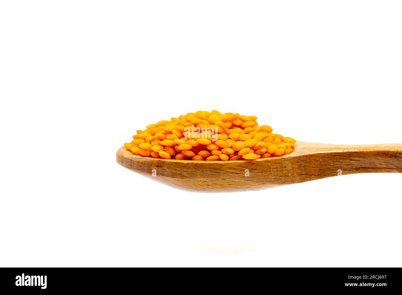Red lentils on wooden spoon. Pile of Red lentils isolated on white background. close up Stock ...