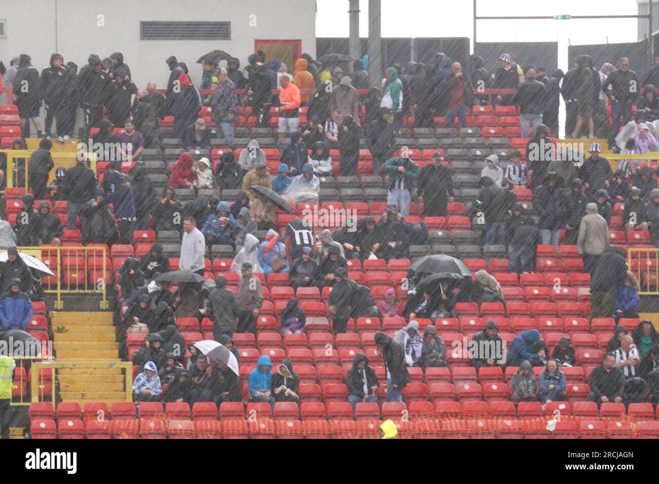 Fans in the stands get caught in rain shower before the pre-season ...