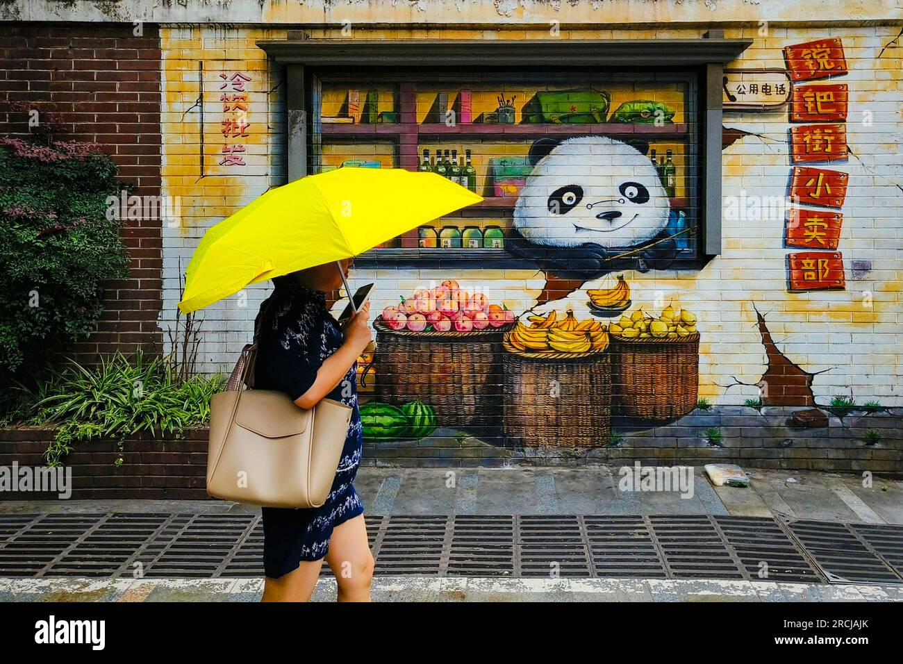 Chengdu, June 25. 8th Aug, 2023. A visitor walks on a gourmet street in ...
