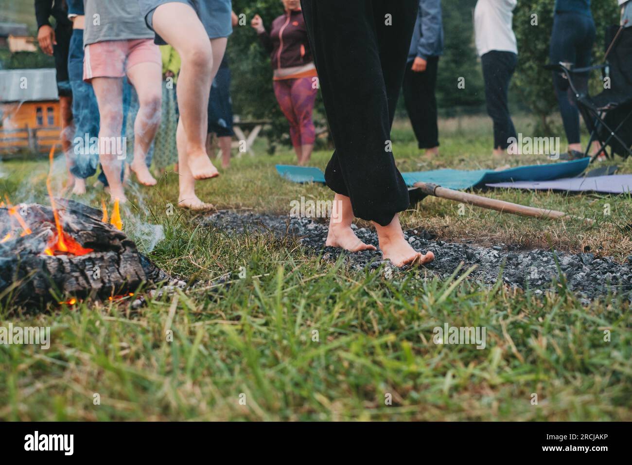 Coal walking or fire walking. Barefoot person on burned wood and hot ...
