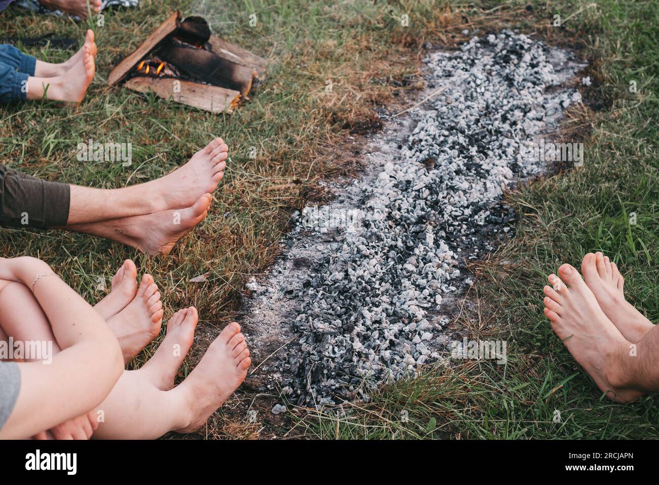 Coal walking or fire walking. Barefoot person on burned wood and hot ...