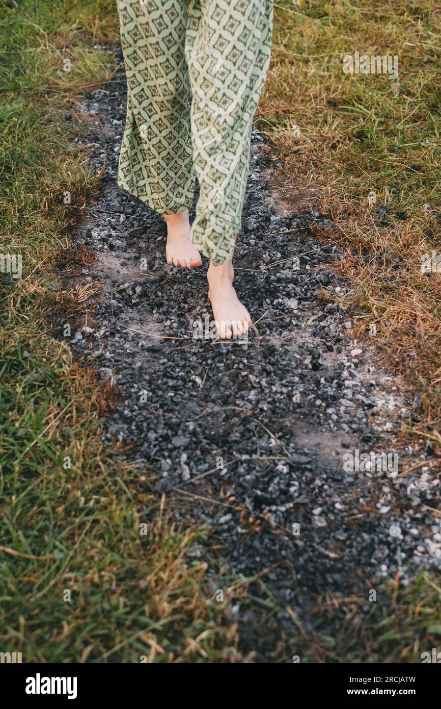 Coal walking or fire walking. Barefoot person on burned wood and hot ...
