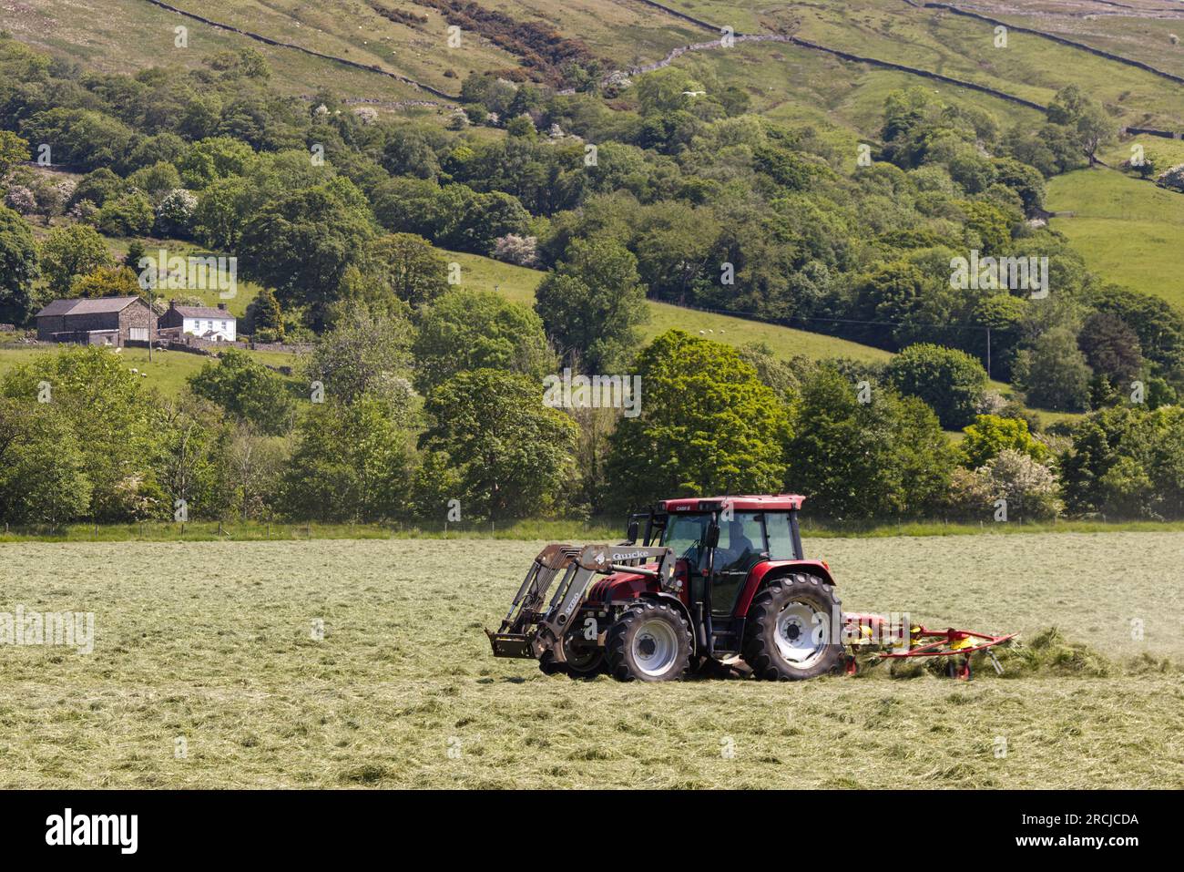 Tedder turning grass hi-res stock photography and images - Alamy