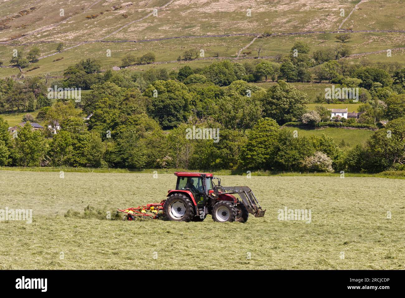 Tedder turning grass hi-res stock photography and images - Alamy