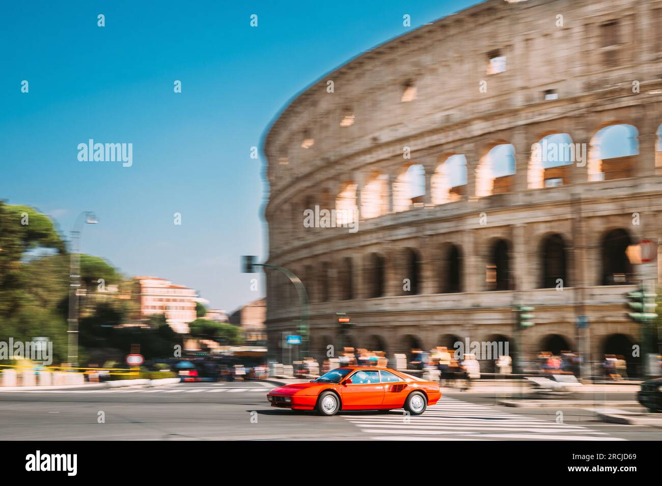 Rome, Italy. Red italian supercar Coupe In Fast Motion Near Colosseum ...