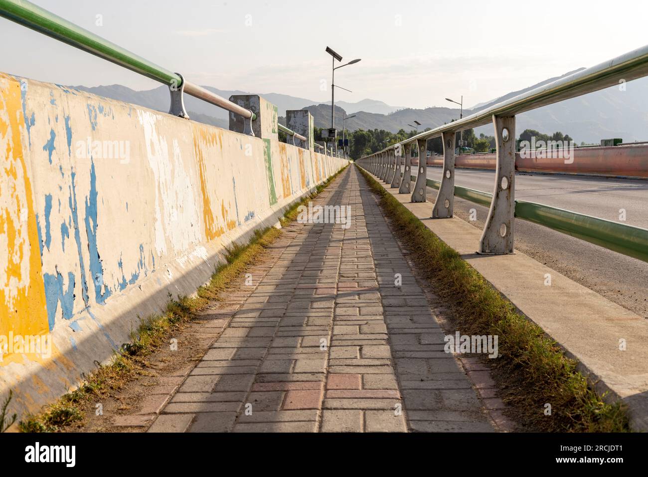 Pedestrian walkway along with a bridge Stock Photo - Alamy