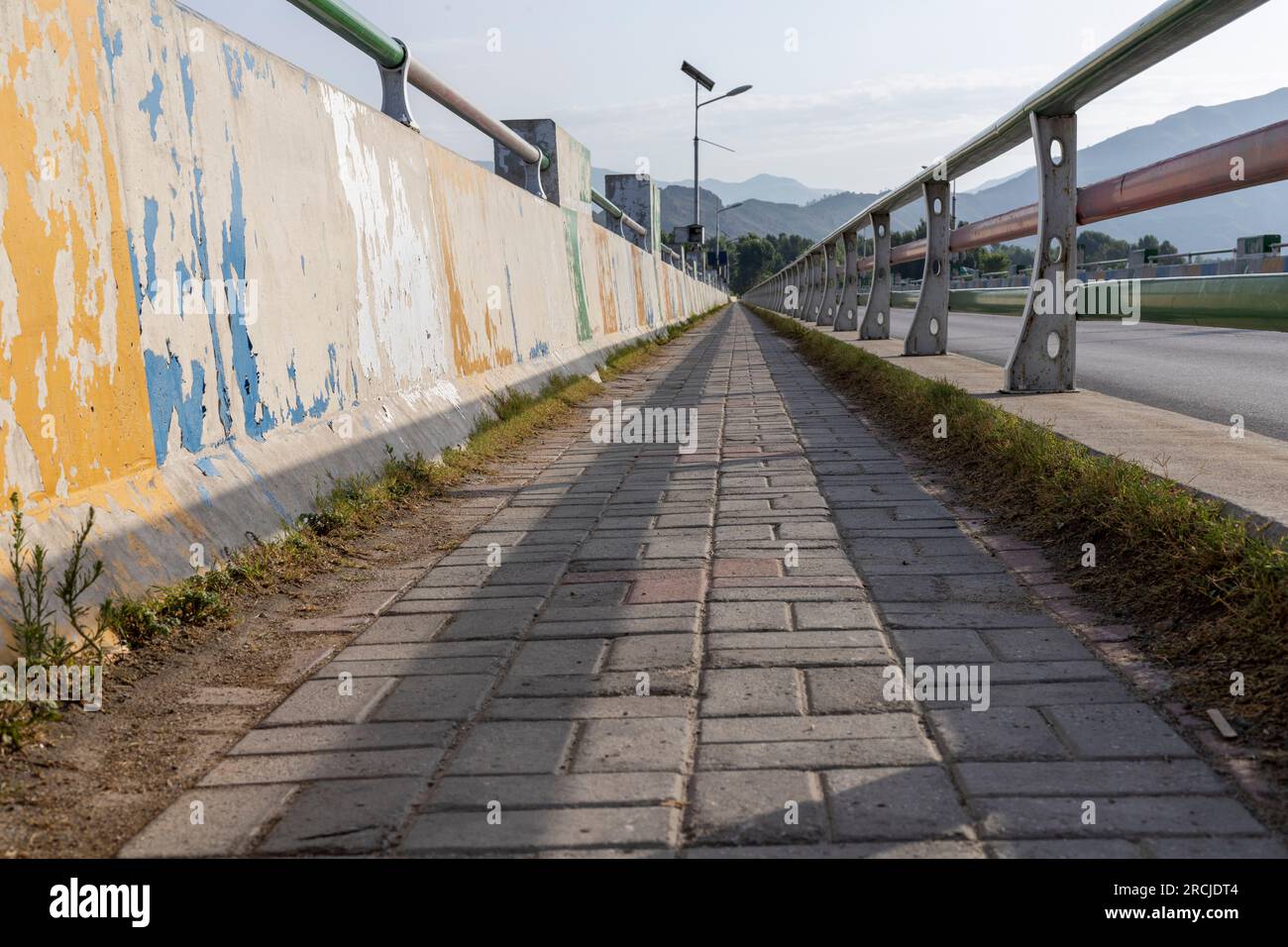 Pedestrian walkway along with a bridge Stock Photo - Alamy