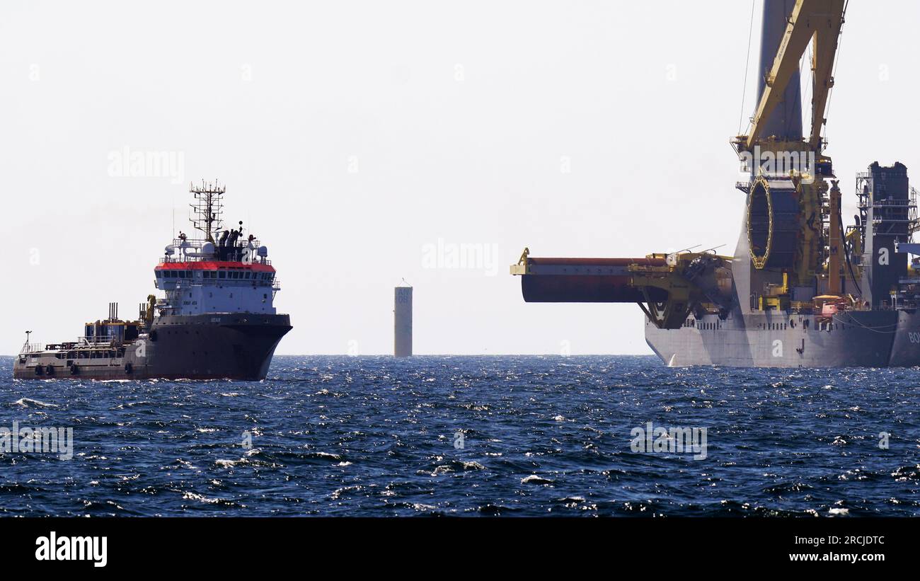 A monopile hangs over the deck of the crane ship Bokalift 2, flagged in ...