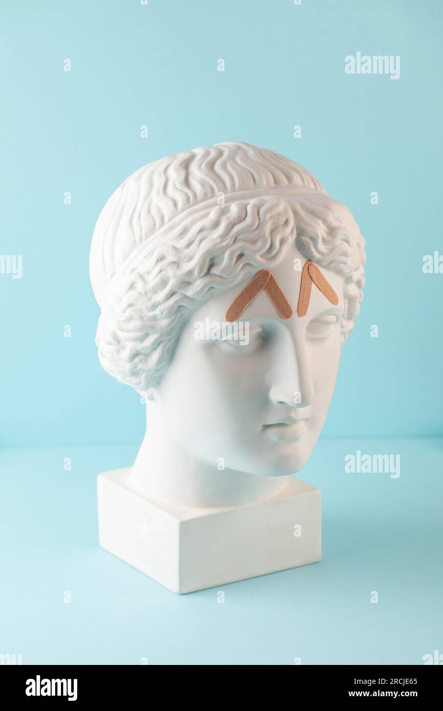 Beige tapes for the face on the bust on a blue background. Non-surgical ...