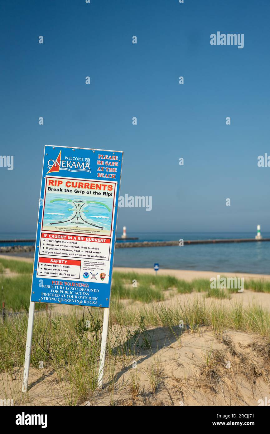 Rip current warning sign at the beach along Lake Michigan Stock Photo ...