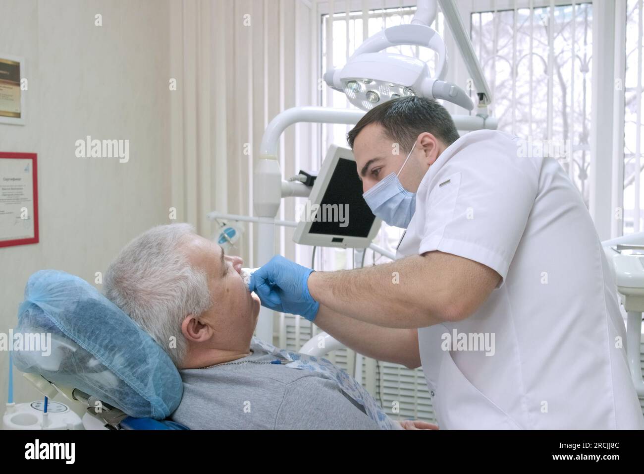 Man dentist making casts of elderly patient teeth to make removable ...