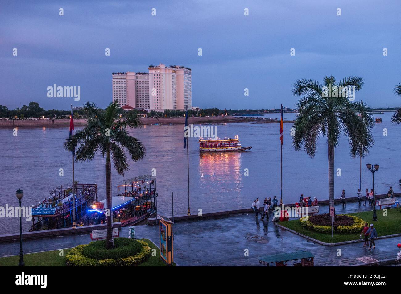 A dinner cruise boat. Riverboat traffic on The Tonle Sap River at dusk ...