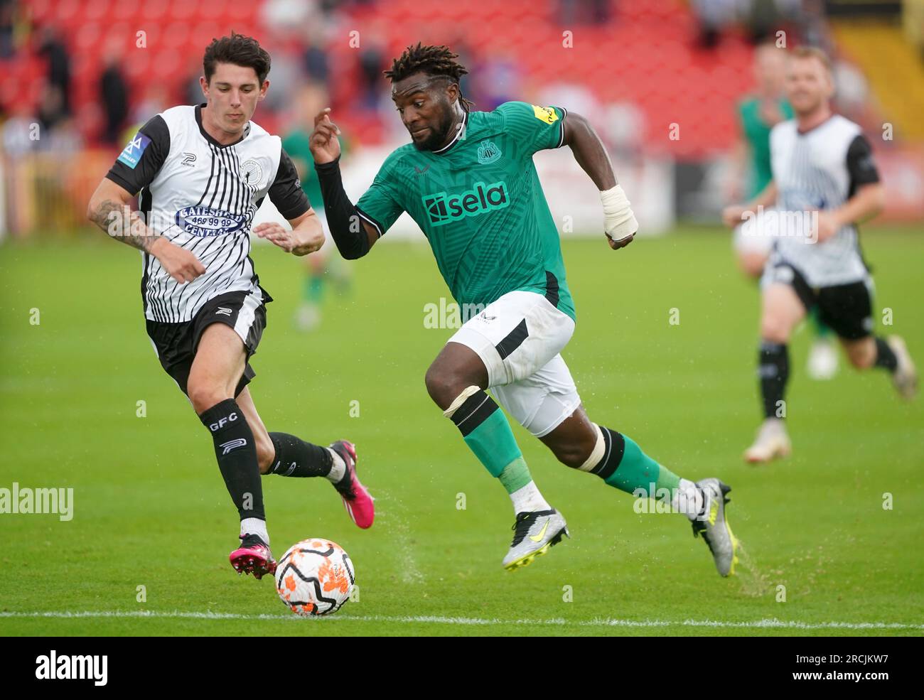 Gateshead's Jordan Hunter (left) and Newcastle United's Allan Saint ...