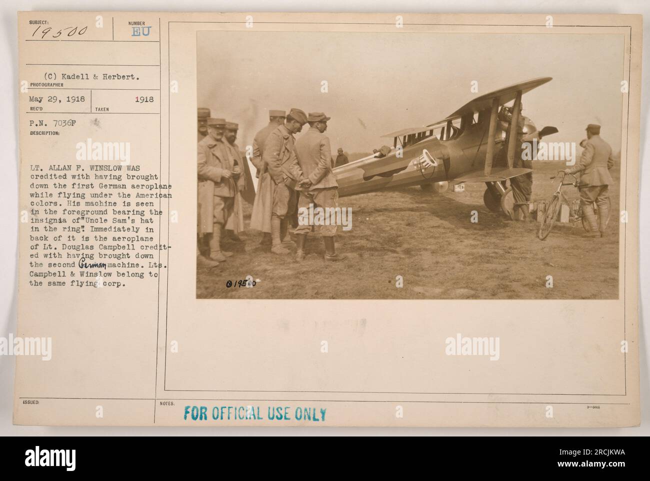 Lt. Allan F. Winslow is seen in the foreground of the image, flying an ...