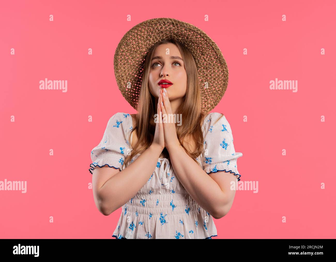 Young woman praying, begs to apologize her, she is guilty. Pink ...