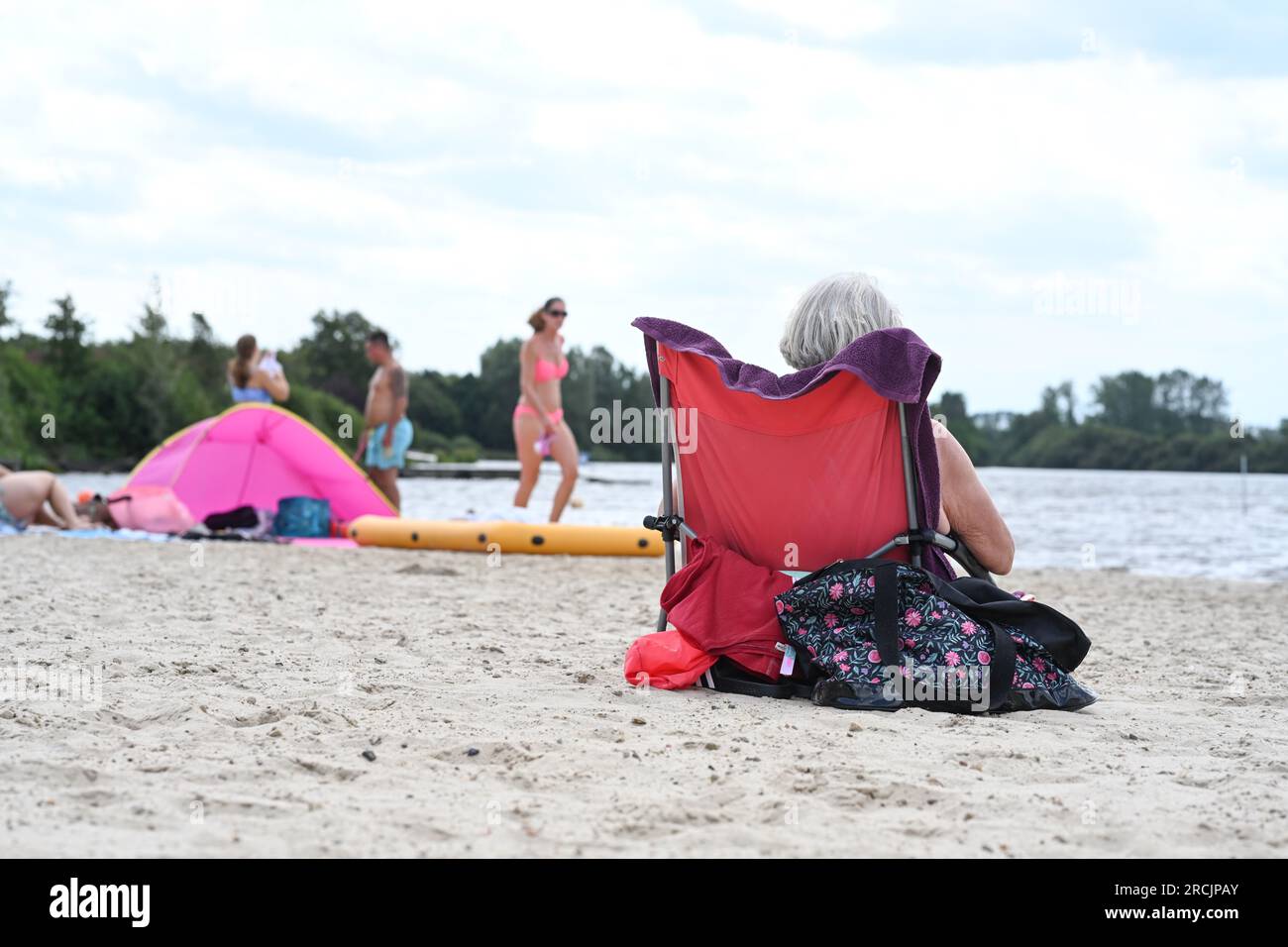 Timmel, Germany. 15th July, 2023. A woman sits in a deck chair at a ...