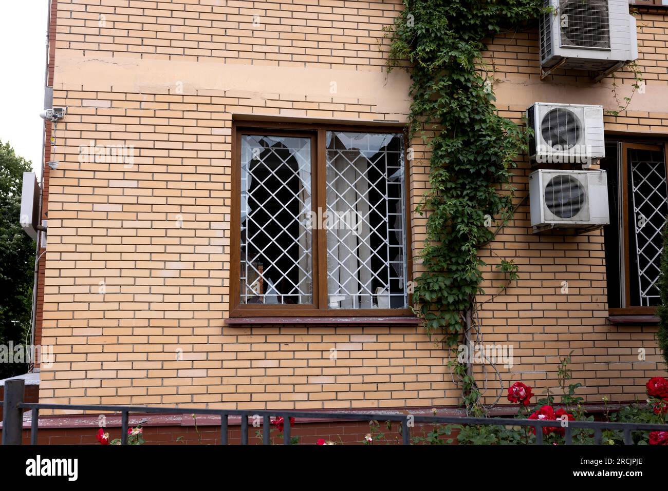 Broken windows of civilian building of bomb explosion. Shards of glass ...