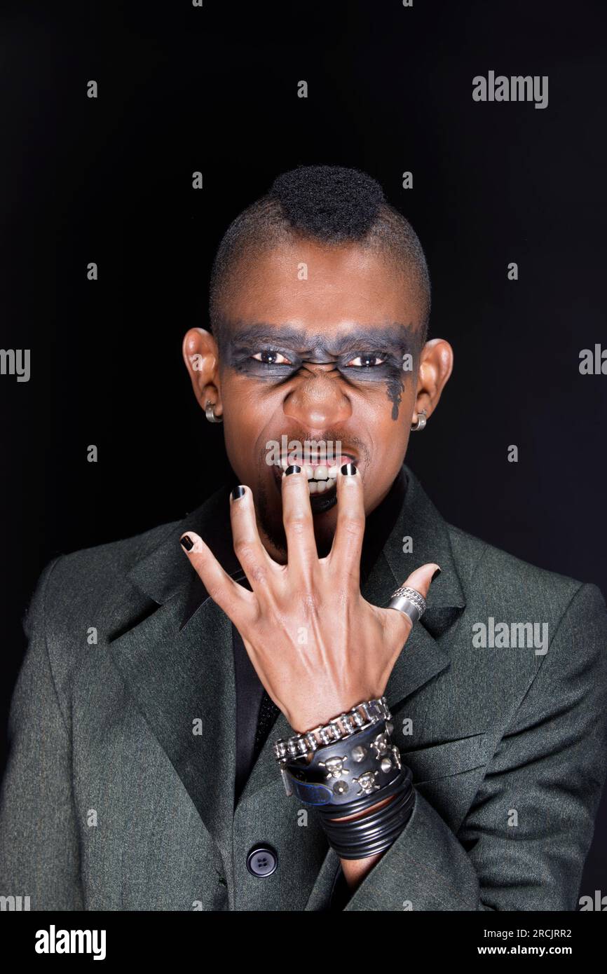 african american rapper with a scary look in a suit with tear makeup ...