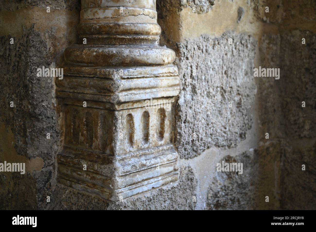 Ancient marble carved column base in the exterior of the Baroque style ...