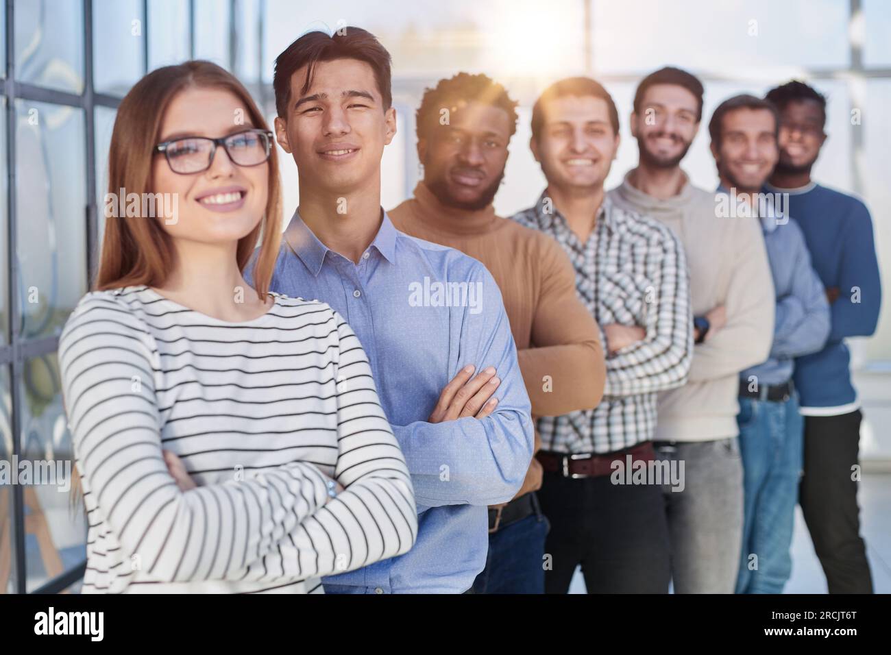 Portrait of multicultural office staff standing in the lobby in a row ...