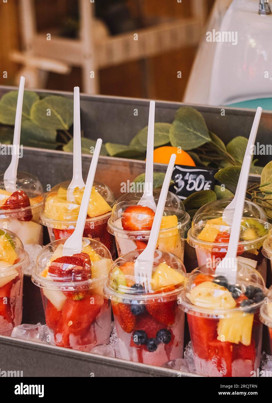 Cups of cut fruit to take away full of vitamins Stock Photo - Alamy