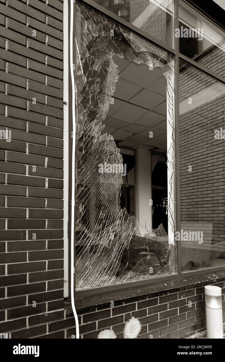 Broken windows of civilian building of bomb explosion. Shards of glass ...