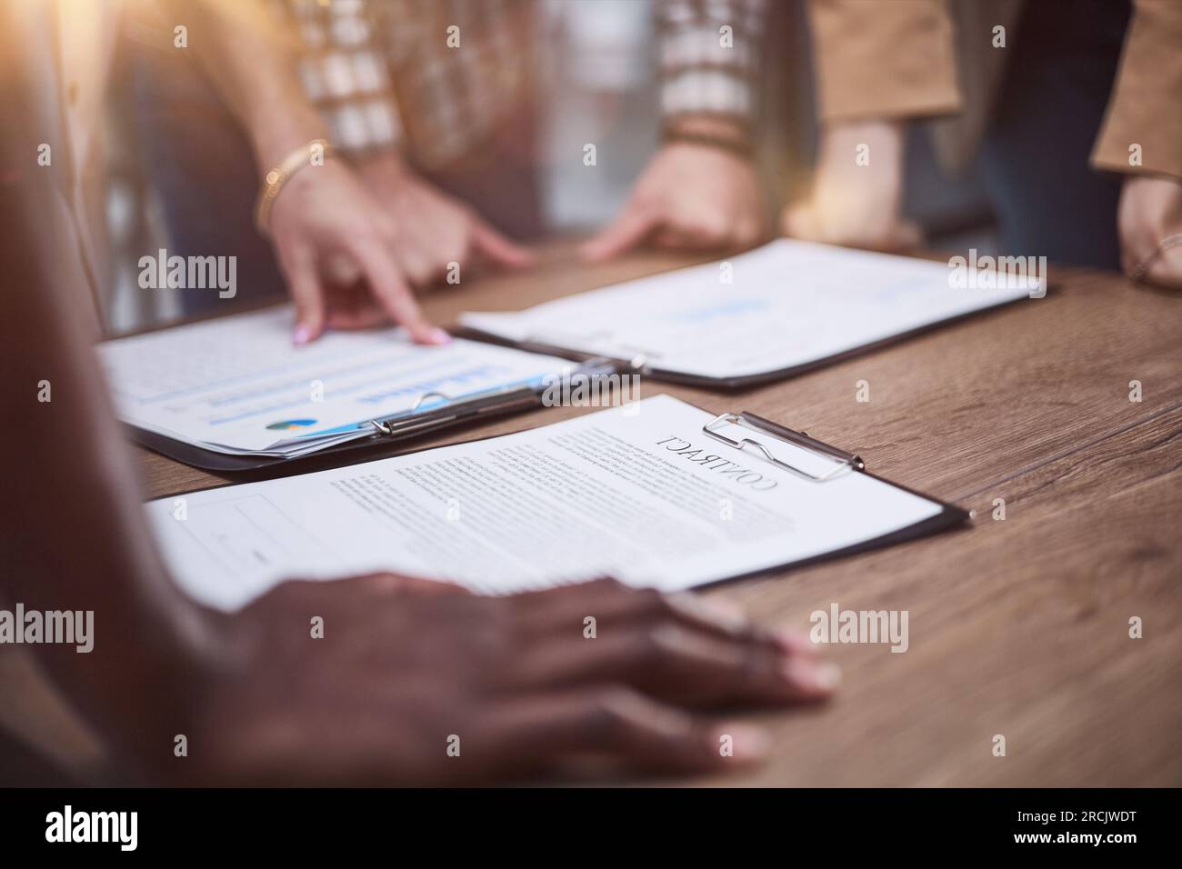 Contract with hand on table signs business transaction Stock Photo - Alamy