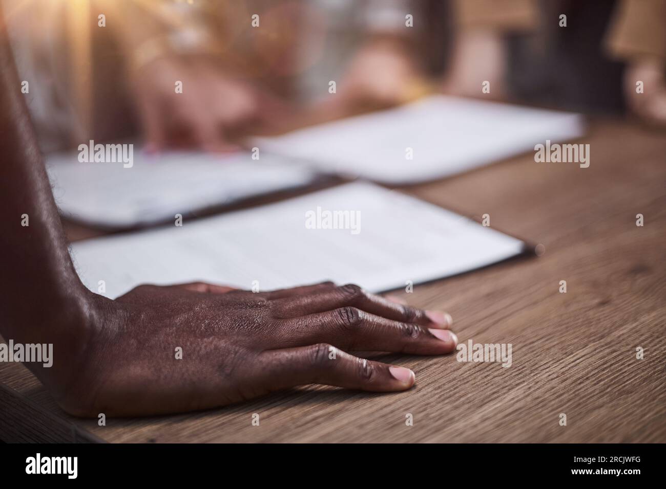 Contract with hand on table signs business transaction Stock Photo - Alamy