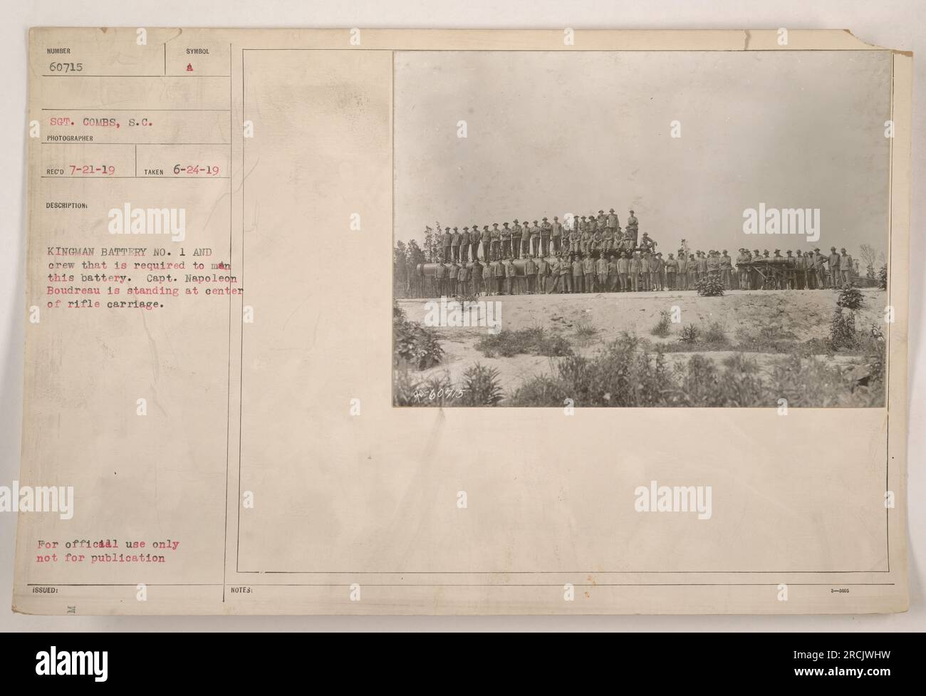 Captain Napoleon Boudreau stands at the center of the rifle carriage of ...