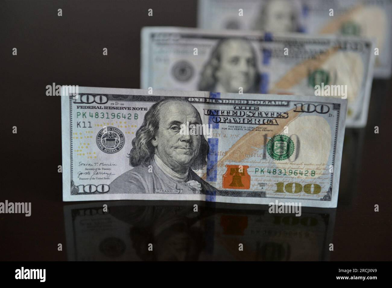 In this photo illustration, a 100 yuan banknote and 100 US dollar ...