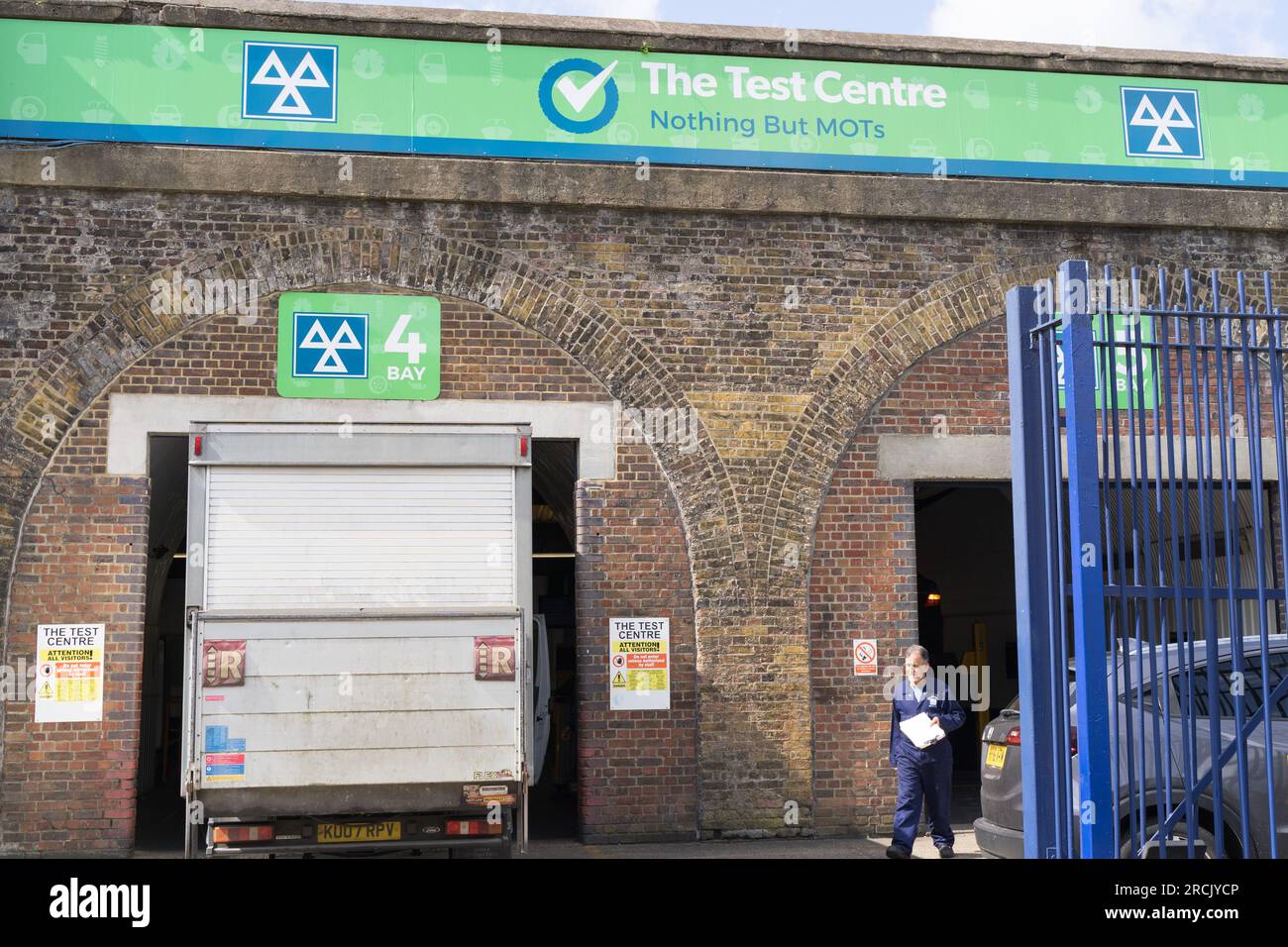 A truck revers out of number four MOT test station bays under railway ...