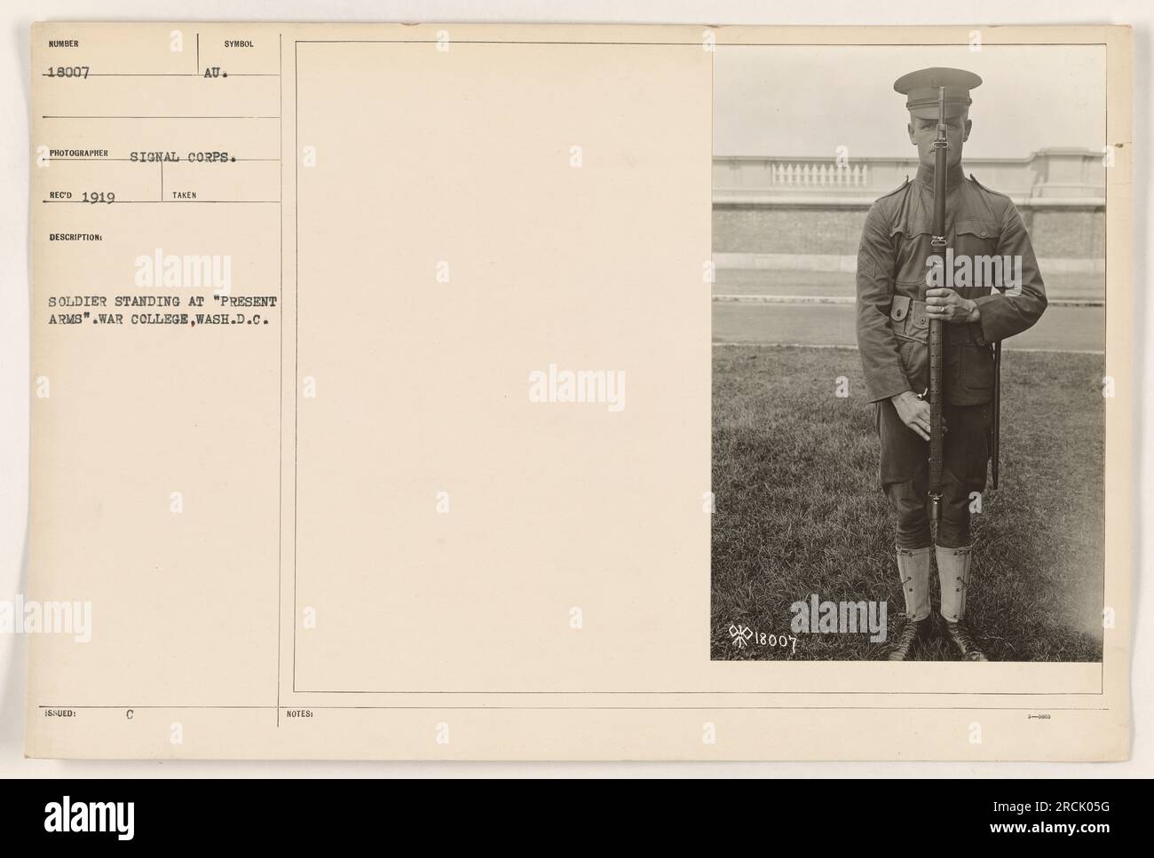 Soldier standing at "present arms" during a military activity at War ...