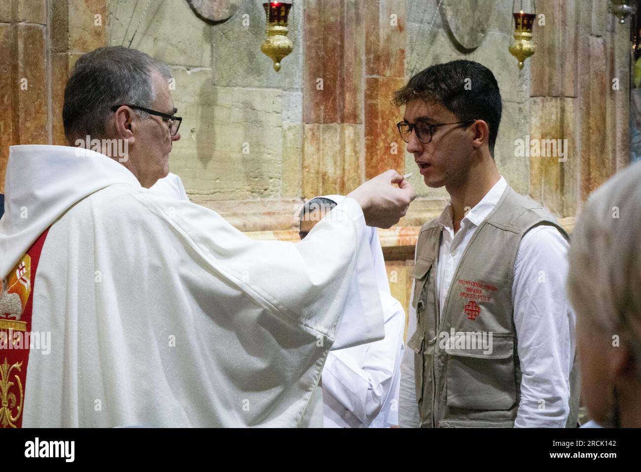 Jerusalem, Israel. 15th July, 2023. A priest giving the communion to a ...