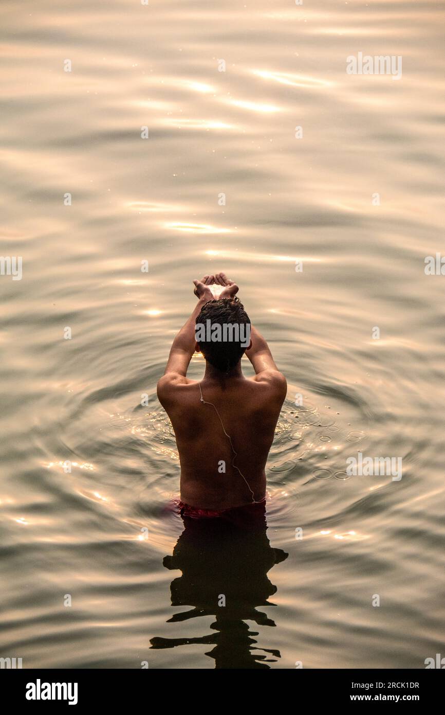 Offering water to the rising sun in the Ganges, Varanasi, India Stock ...