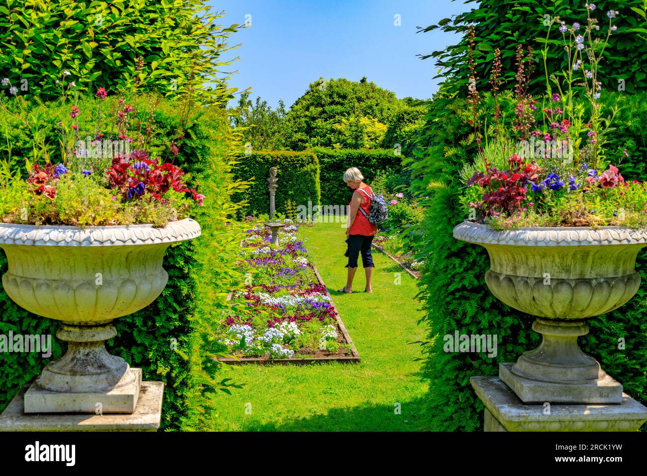 A lady visitor admiring the colourful central border of the Canal ...