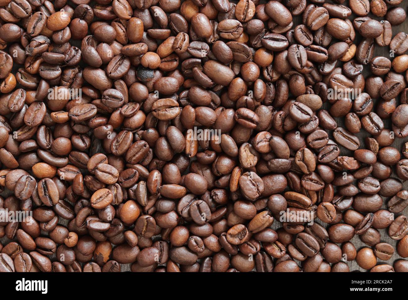 Top view of background representing halves of dark brown coffee beans ...