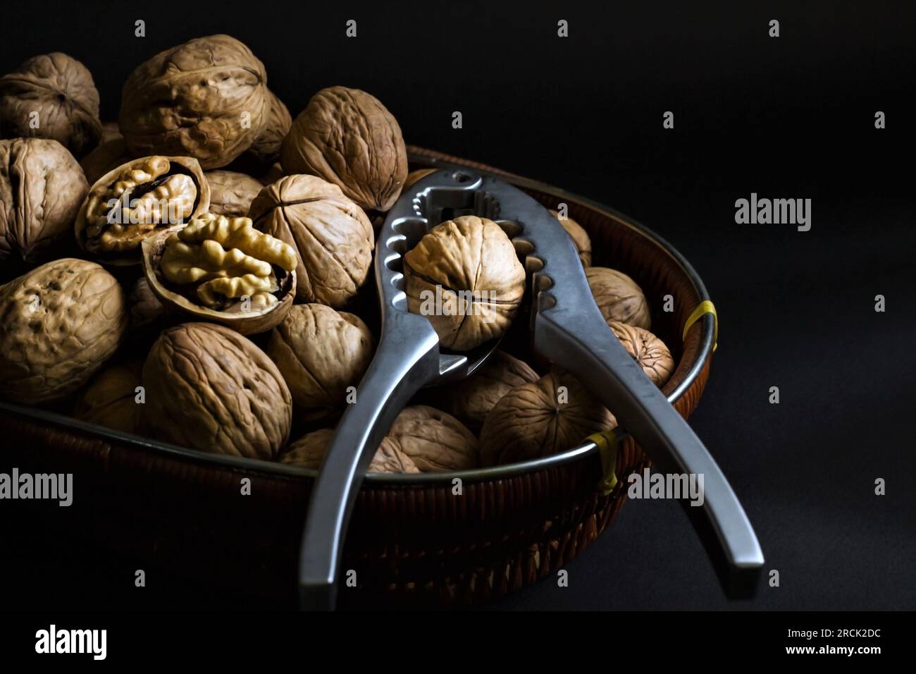 Newly harvested walnuts, designed in wicker basket,with a walnut ...