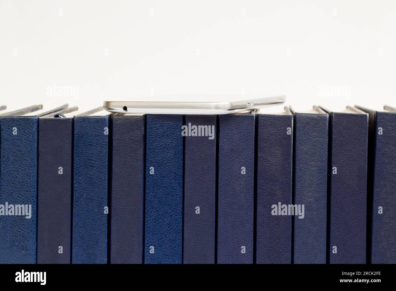 Hard cover books,encyclopedia series lined up on white with copy space ...