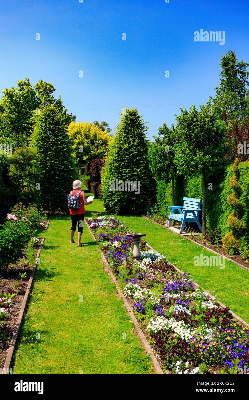 A lady visitor admiring the colourful central border of the Canal ...