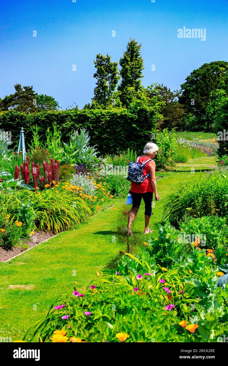 A lady visitor admiring the colourful Formal Flower Garden at the Holme ...