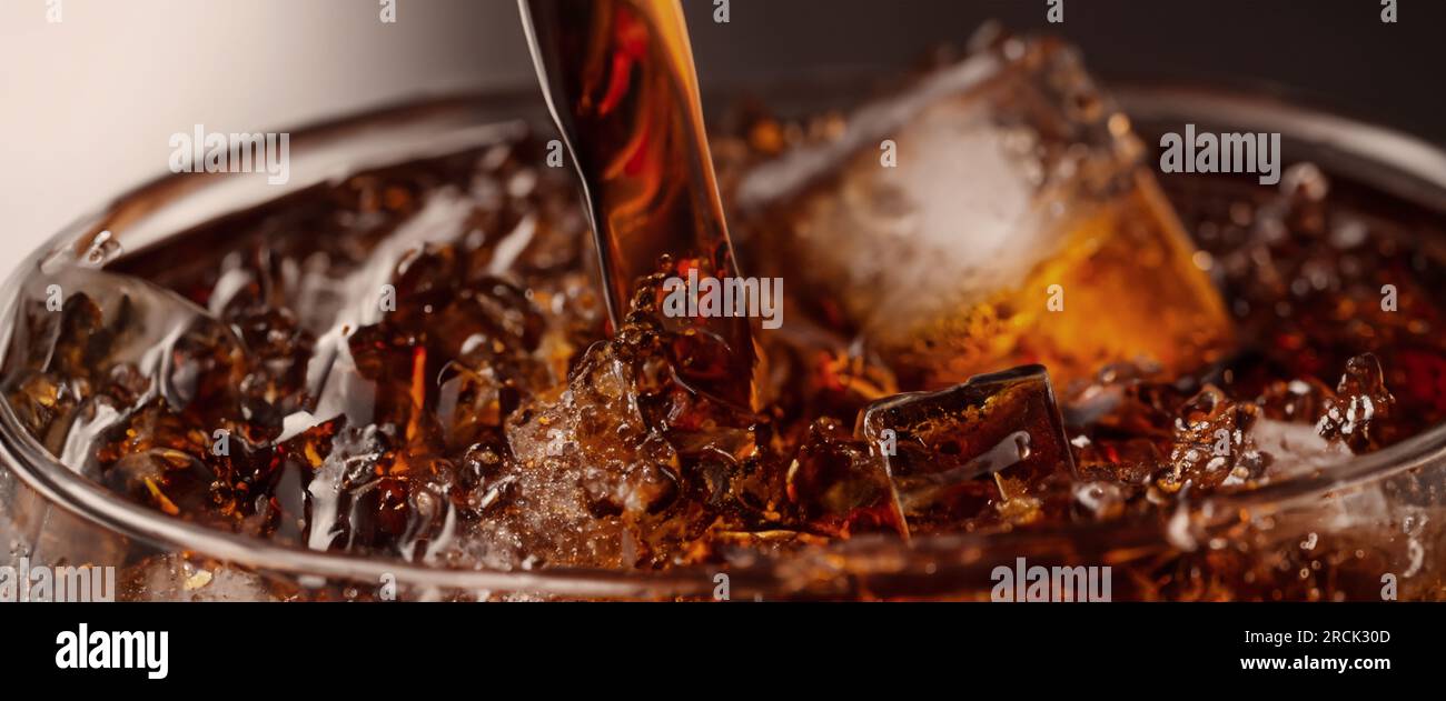 Splashing of Cola and Ice. Cola soda and ice splashing fizzing or ...