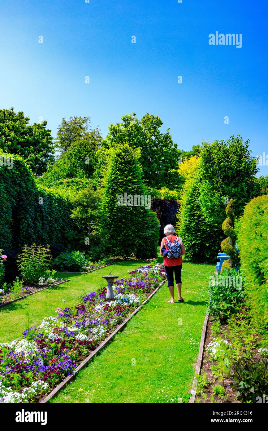 A lady visitor admiring the colourful central border of the Canal ...