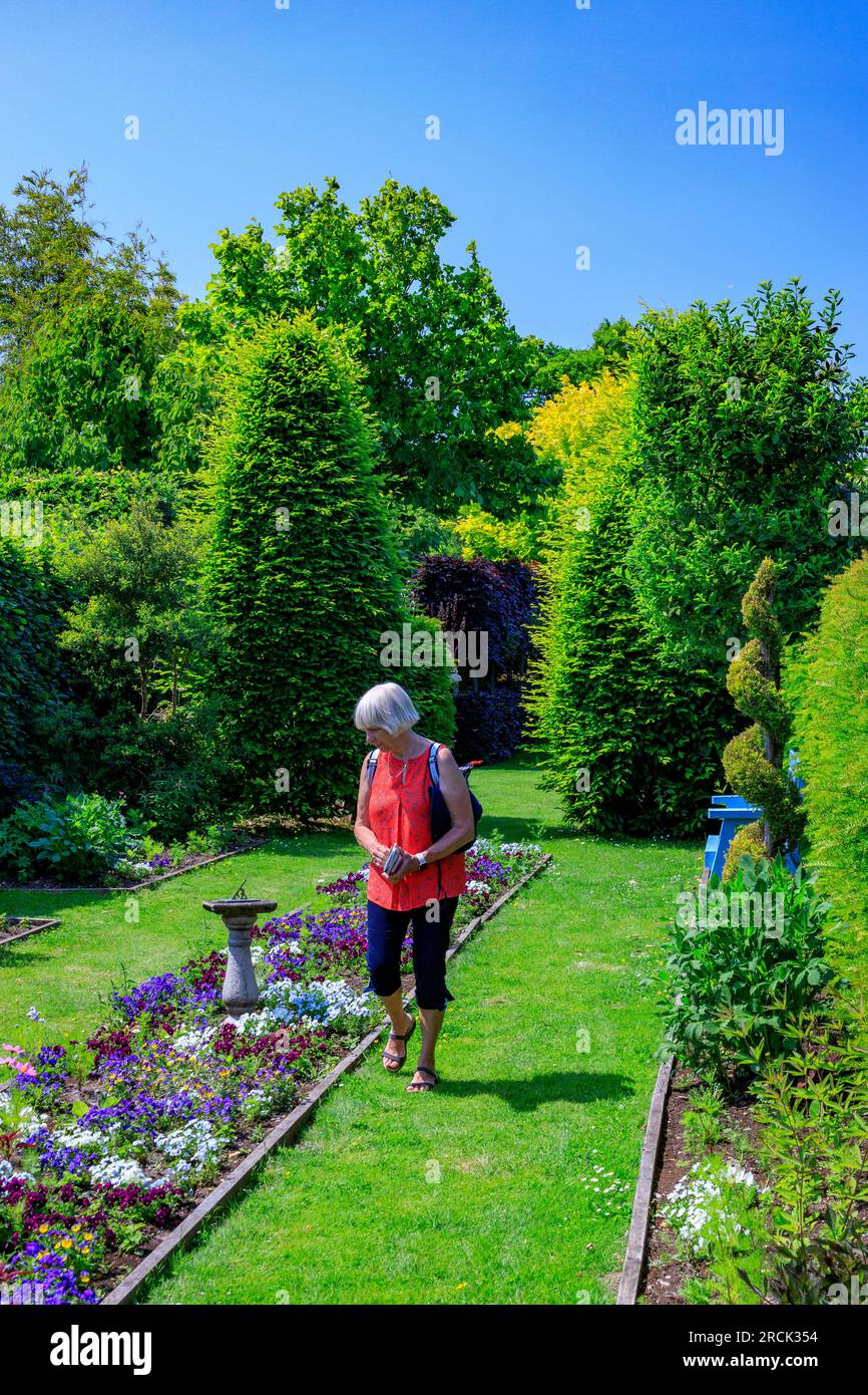 A lady visitor admiring the colourful central border of the Canal ...
