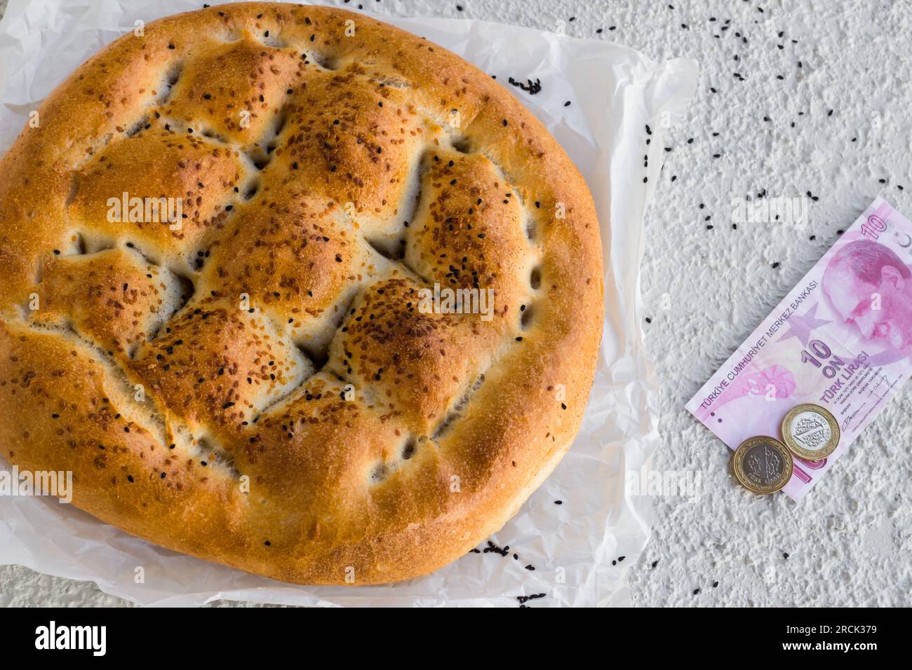Traditional Turkish Ramadan Bread with baking paper next to twelve ...