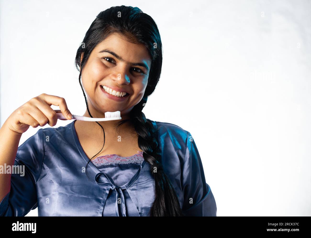An Indian woman female girl brushing teeth on white background with ...