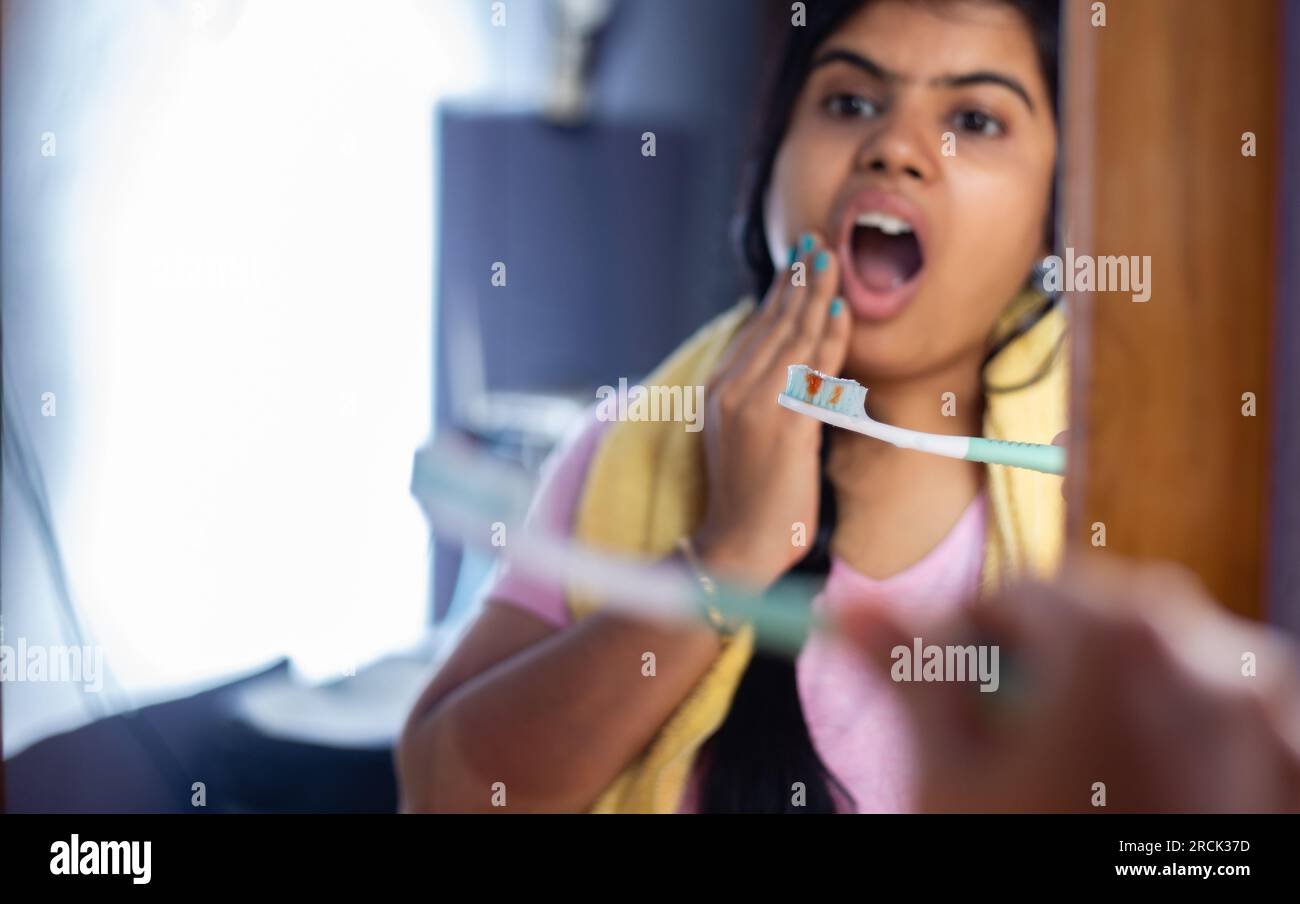 An Indian woman female girl in front of mirror facing dental problem ...