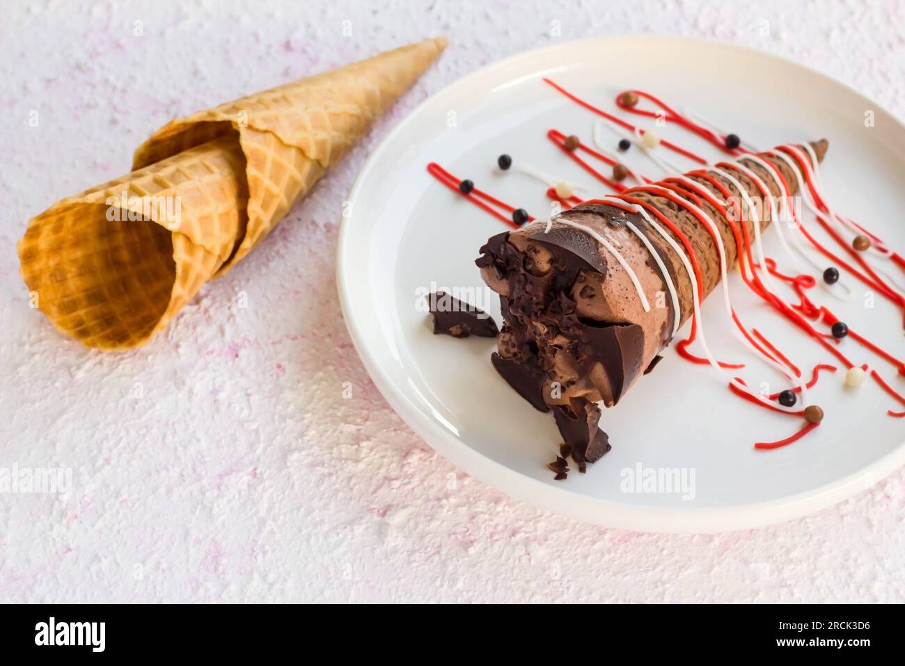 Cocoa and caramel cornet ice cream designed with decorative candy in a ...