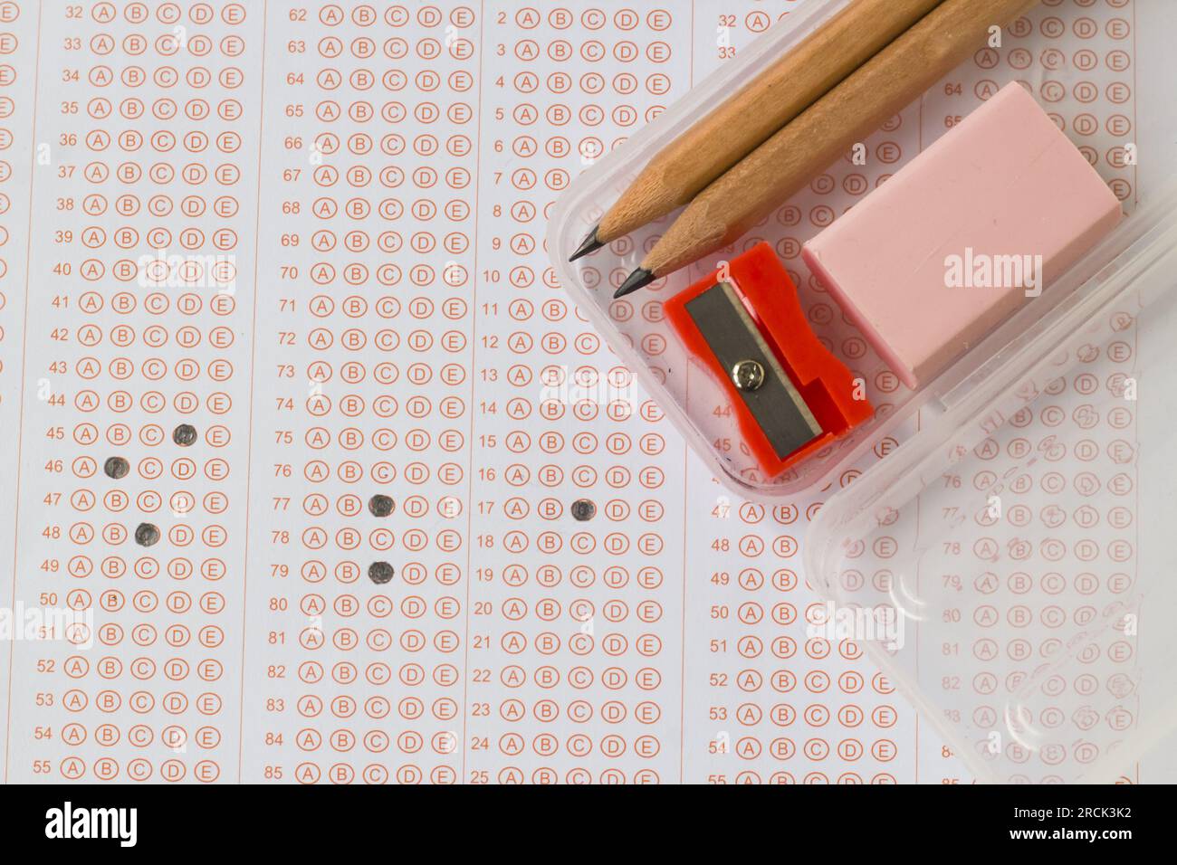 wooden pencil,eraser and sharpener on exam sheet,education concept ...